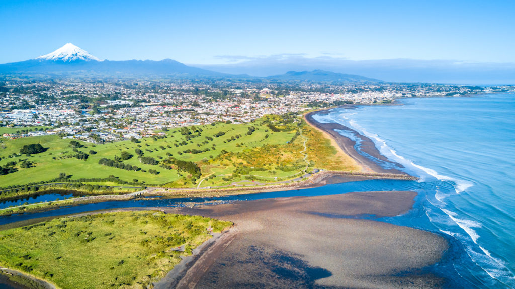 Aerial view on Taranaki coastline with a small river and New Plymouth ...